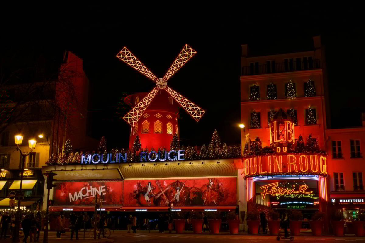The windmill blades on the roof of the Moulin Rouge in Paris are ...